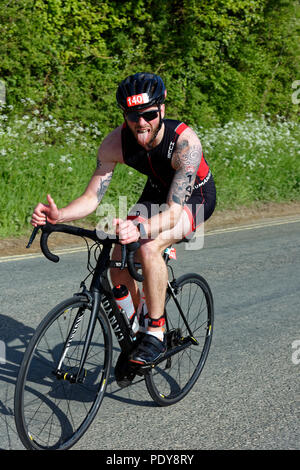Triathlon athlete riding a bike Stock Photo - Alamy