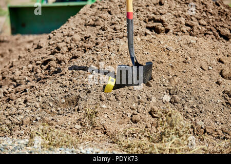 Close up of a shovel stuck into a dirt pile Stock Photo: 215122863 - Alamy