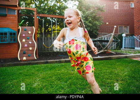 Wet Little Girl After Playing With The Water Jet In Swimsuit Stock