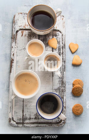 Many cups of coffee on with cookies checkered napkin Stock Photo - Alamy