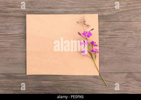 Blooming sally purple flowers with craft paper blank on old grunge ...