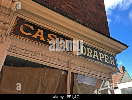 Old fashioned Victorian drapers shop with fabric and clothes on sale ...