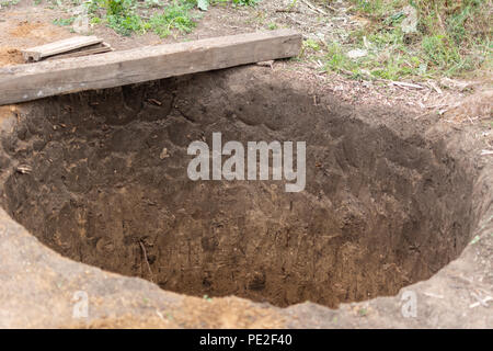 Round pit for a septic tank. Sewerage construction Stock Photo - Alamy