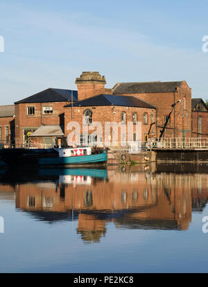 Barge moored in Gloucester Docks and converted Victorian warehouses ...