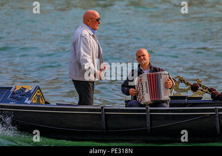 Music boat on the Grand Canal in Venice. The musicians are sitting in a ...