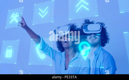 Happy multiethnic couple getting experience using VR headset glasses of ...