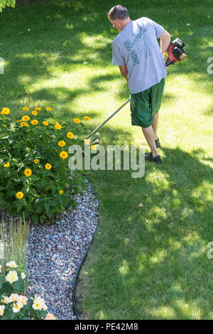 Man doing yardwork Stock Photo - Alamy