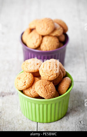 meringue almond cookies in bowls on wooden background Stock Photo - Alamy