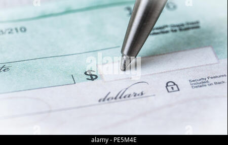 Making payments , writing the check Stock Photo - Alamy