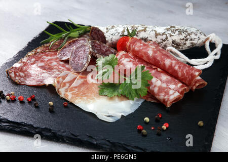 Food tray with delicious salami, coppa, fresh sausages and herbs. Meat ...