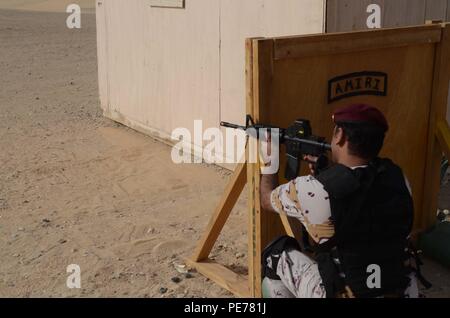 A sniper with Kuwait’s Amiri Guard fires his rifle during an urban ...