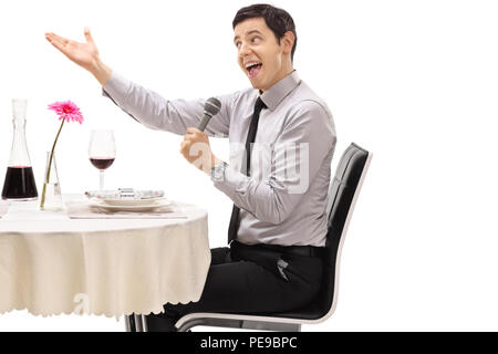 Young man singing into a microphone isolated on white background Stock ...