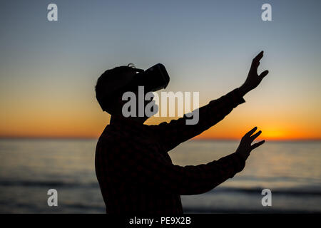 Virtual Realty is here Man wearing virtual reality glasses on the over ...