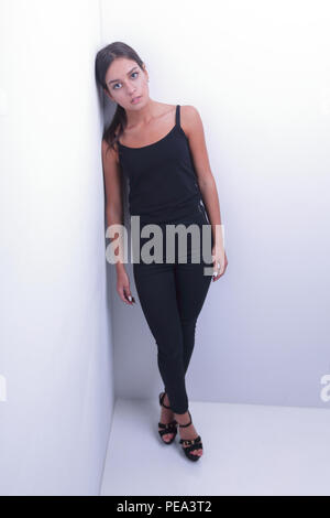 Young woman standing with doubt expression at park Stock Photo - Alamy