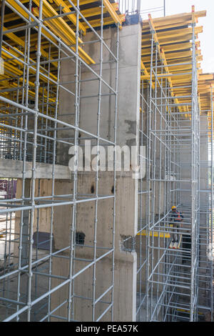 Worker on scaffolding performs city-mandated facade inspection and ...