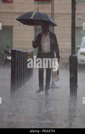 Torrential rainstorm in London catches commuters and tourists by ...
