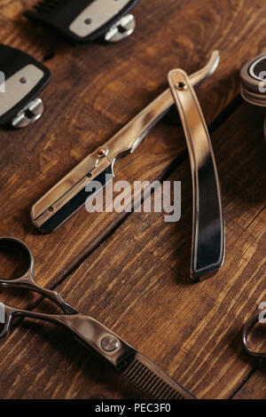 Straight razor on wooden surface Stock Photo - Alamy