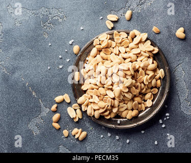roasted salted peanuts on yellow background, top view Stock Photo - Alamy