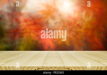 Pine wood counter with blurred autumn leaves background Stock Photo - Alamy