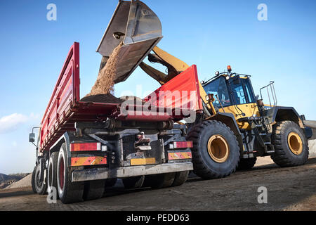 Excavator moving sand Stock Photo - Alamy