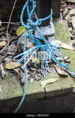 Nylon rope tied into a knot with blue background Stock Photo - Alamy