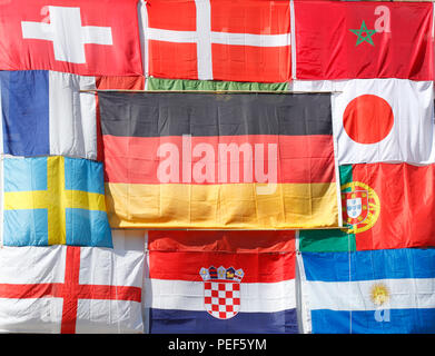 A different colorful flags on the wall Stock Photo - Alamy