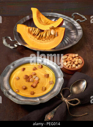 Tasty pumpkin cream soup served seeds and parsley Stock Photo - Alamy