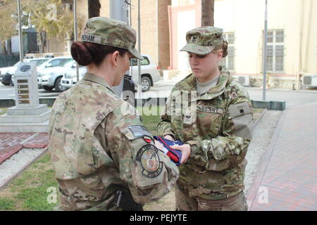 Yeoman 2nd Class Jordan Guevara, center, salutes a flag flown in honor ...