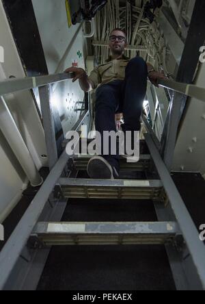 A scout walks down a ladderwell aboard USS Sentry (MCM 3) during a tour ...