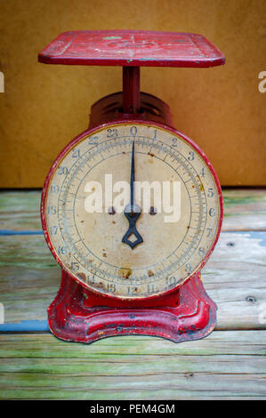 Old fashioned red antique weight measuring scale Stock Photo - Alamy