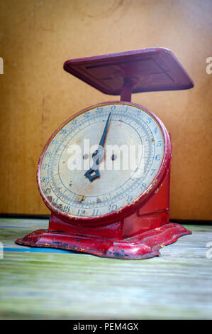 Old fashioned red antique weight measuring scale Stock Photo - Alamy