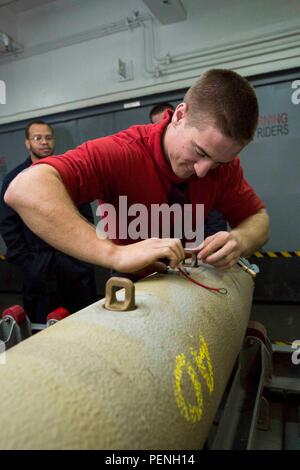 Aviation ordnance personnel install an MK-122 safety switch on a GBU-32 ...