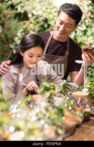Young happy asian women decorating Christmas tree Stock Photo - Alamy