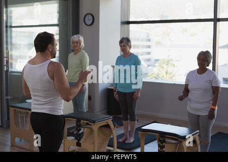 Trainer instructing group of senior women man Stock Photo - Alamy