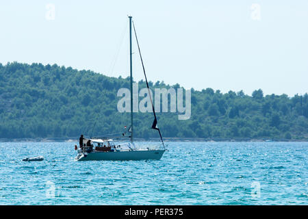 A picture of several boats floating on the blue ocean during the hot ...