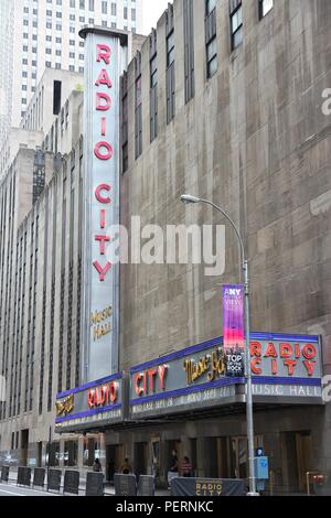People walk past Radio City Music Hall in Manhattan, New York City ...