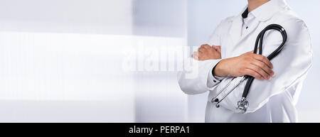 Medical doctor with stethoscope holding the Cross of Health. Concept of ...