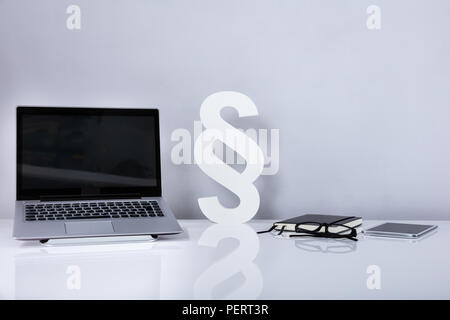 Laptop With Blank Screen And White Paragraph Symbol On Reflective Desk ...