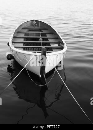 Monochrome image of an empty rowboat in the water Stock Photo - Alamy