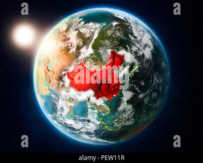 Sunrise above China highlighted in red on model of planet Earth in ...