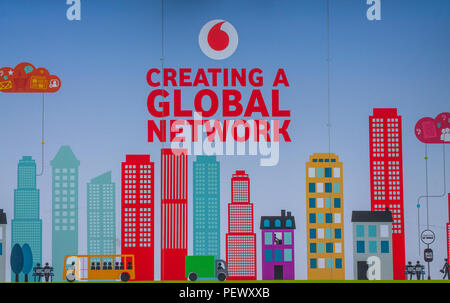Vodafone logo advertising a global network on an advertising hoarding ...