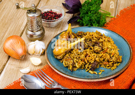 Blue plate with pilaf and meat. Studio Photo Stock Photo - Alamy