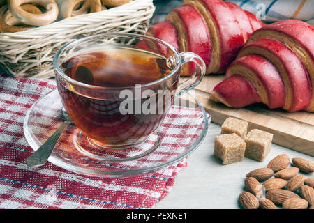 croissants with fruit glaze and another baking and a cup of tea top ...