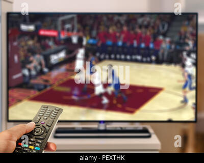 Basketball player sitting on a sofa and watching tv isolated on white ...