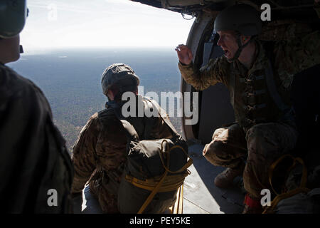 An 82nd Airborne Division soldier signals to his platoon as they ...