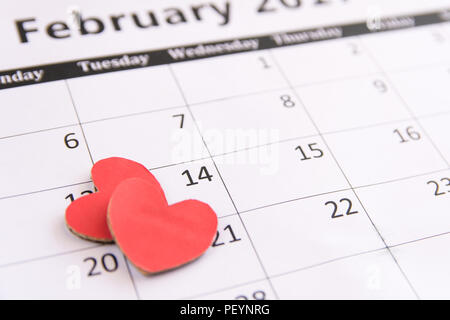 Calendar page and red hearts paper on February 14 of Valentines day ...