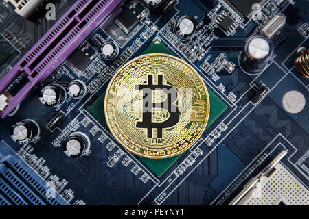 Golden Bitcoin coins on Motherboard, miner with circuit board, pool ...