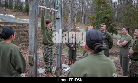 Major Misty Posey demonstrates proper form for pull-ups to Marines at ...