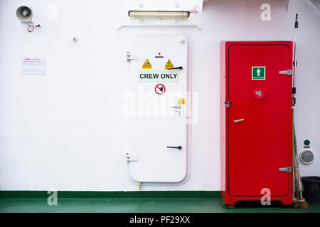 Crew only sign on white door onboard ferry cruise ship Stock Photo - Alamy