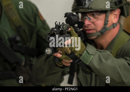 A member of the Georgia State Patrol SWAT team looks on as people walk ...